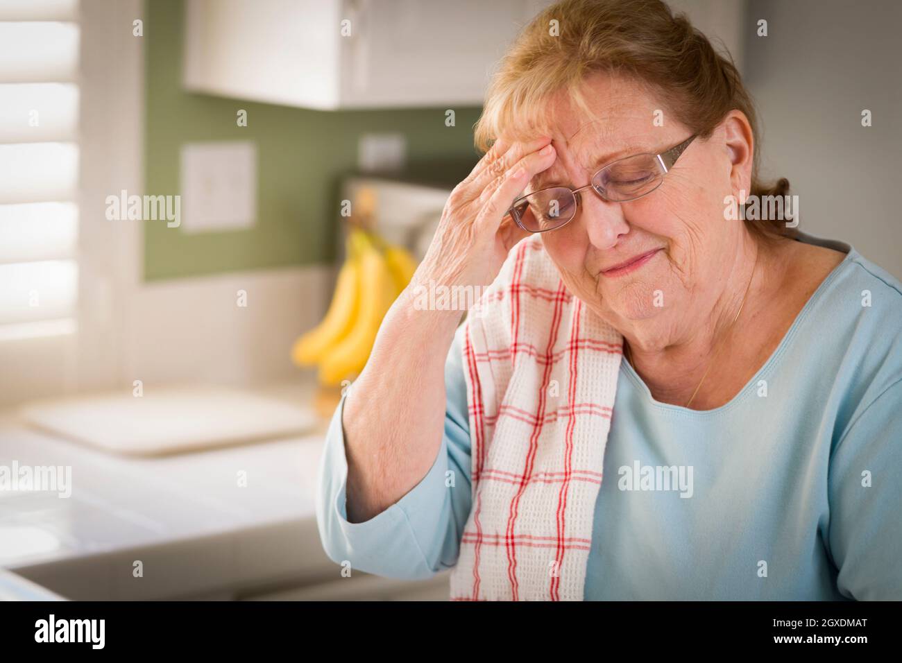 Sad Crying Senior Adult Woman At Kitchen Sink in Home Stock Photo - Alamy