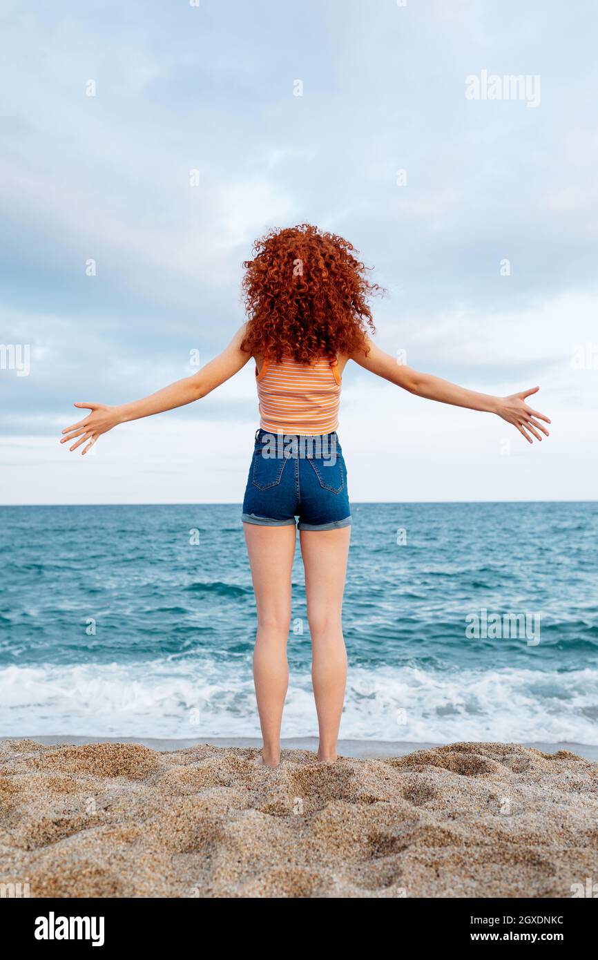 Self assure young Asian lady with long hair in fashionable outfit and ...