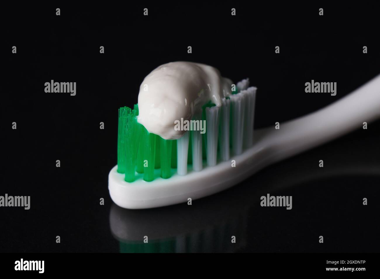 Toothbrush with toothpaste on black background with reflection Stock ...
