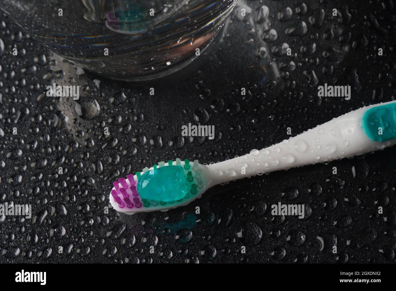 Toothbrush with toothpaste on black background with water drops Stock ...