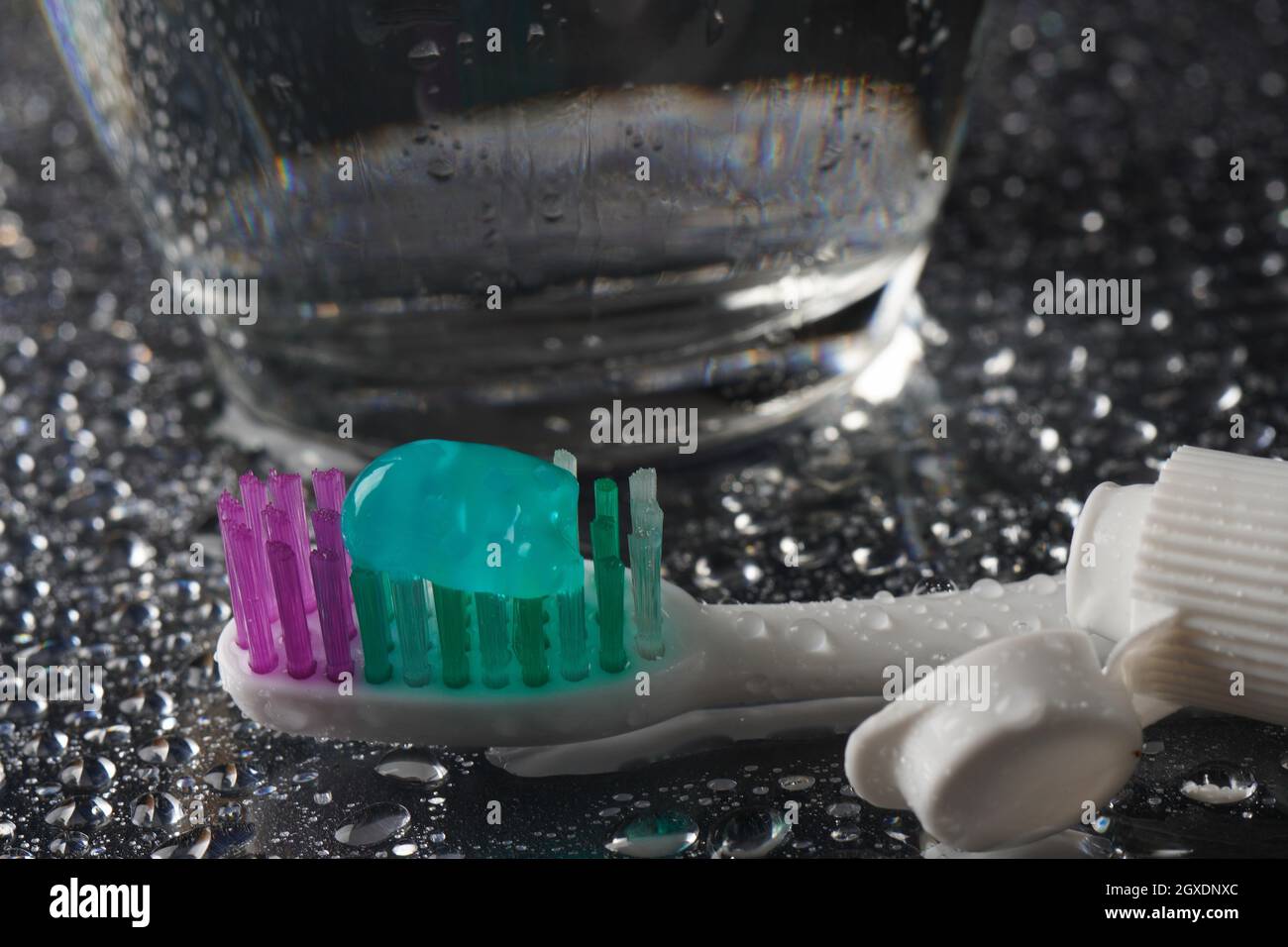 Toothbrush with toothpaste on black background with water drops Stock ...