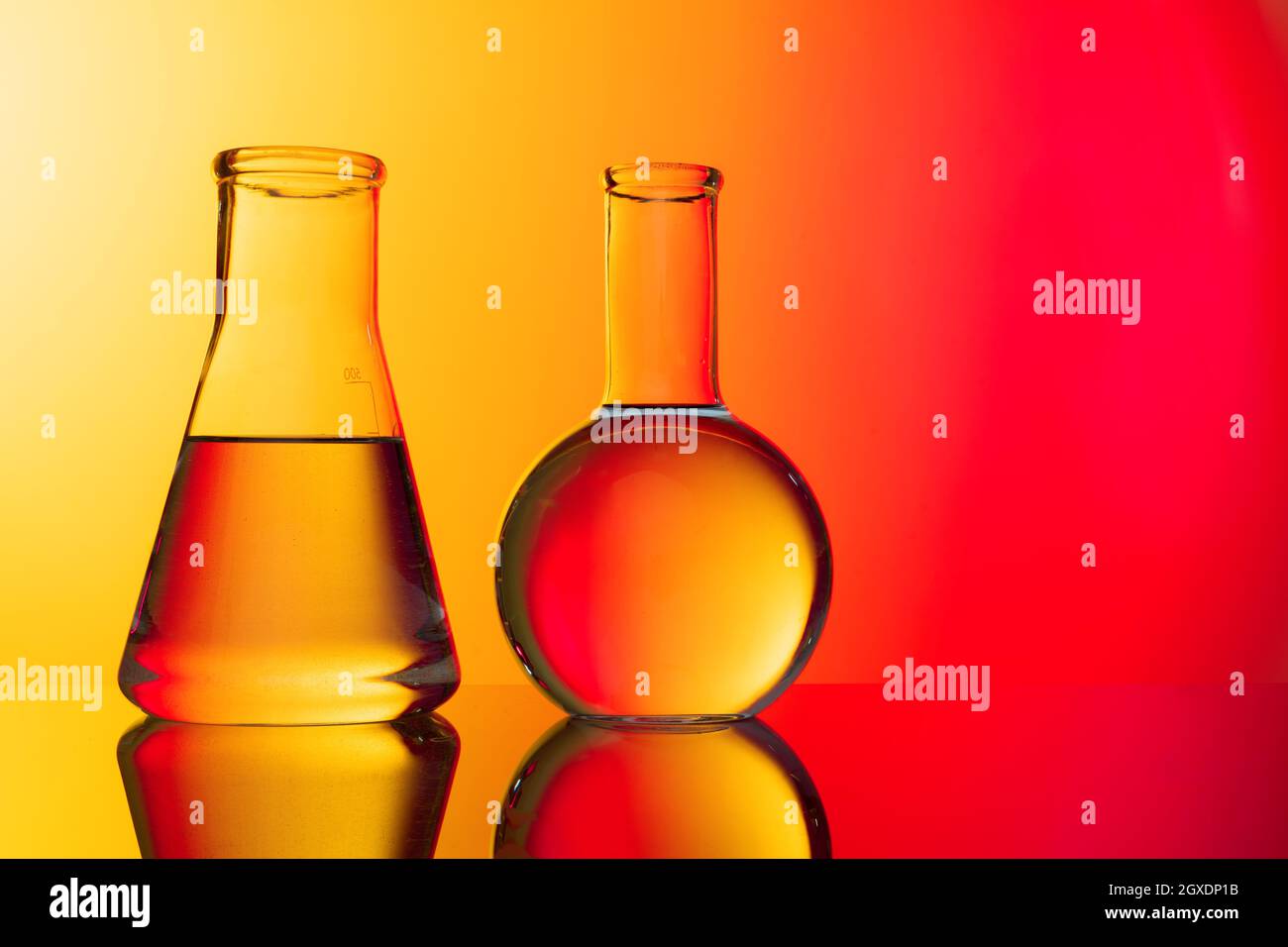 Science concept. Glass test tubes on red background Stock Photo - Alamy