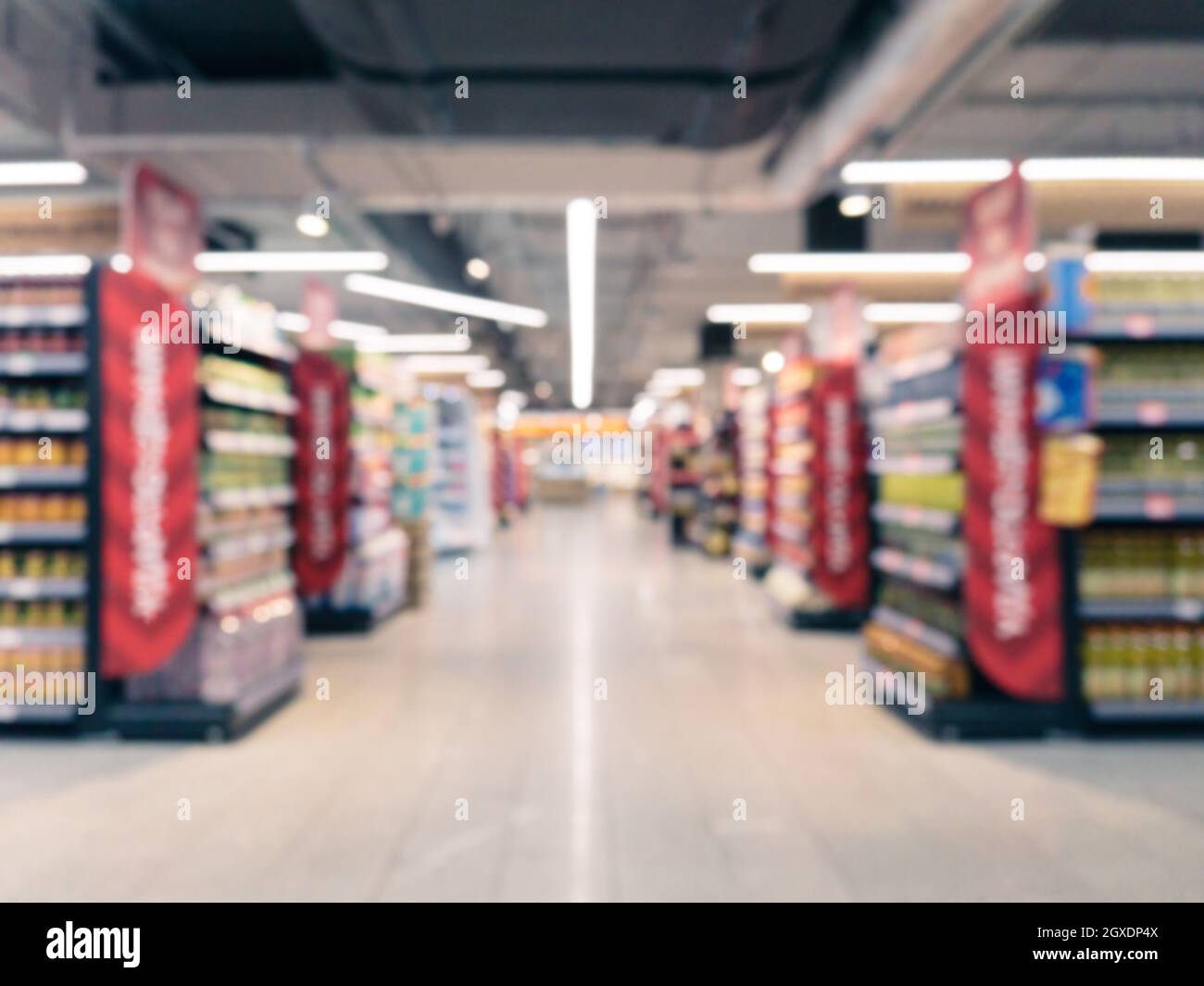 Abstract blurred supermarket aisle with colorful shelves and ...