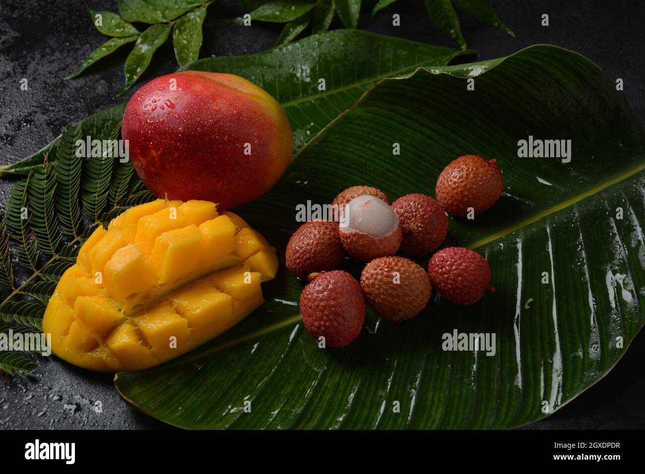 Fresh mango fruit with sliced diced mango chunks on a plate and fresh ...