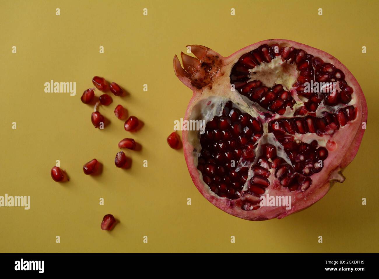 Fresh sliced pomegranates. Half pomegranate and pomegranate grains ...
