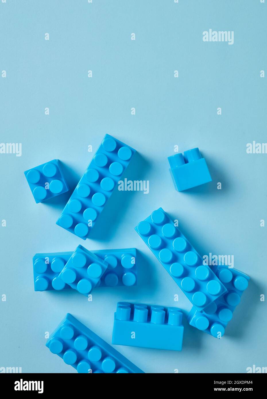 Blue toy bricks on blue background Stock Photo - Alamy