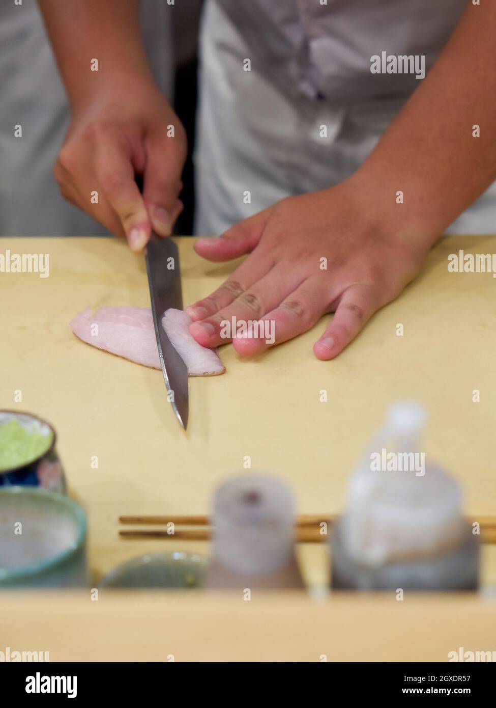 Chef use sharp knife slicing Aburi white fish for sashimi. Enjoy ...