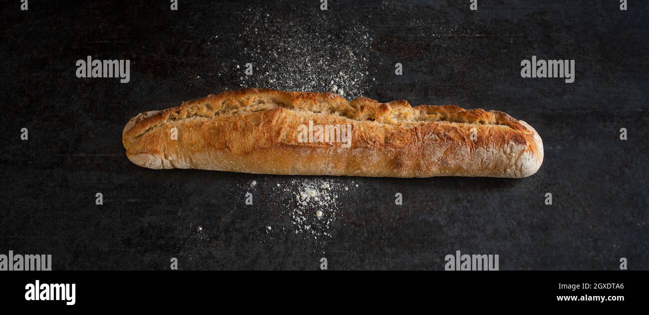 Fresh crispy french baguette on black background. Atmosphäric food ...