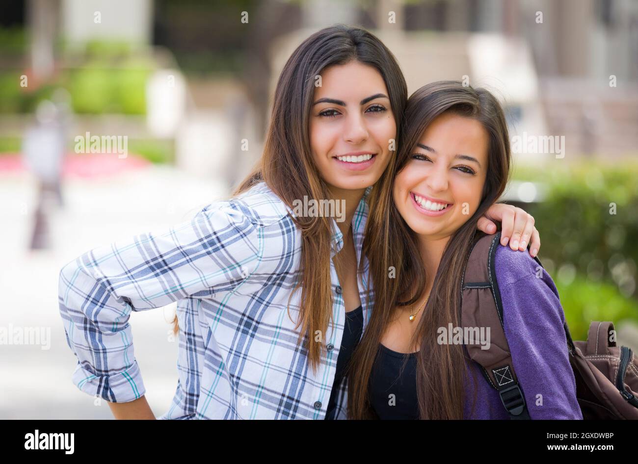 Portrait of Two Attractive Mixed Race Female Students Carrying Backpack ...