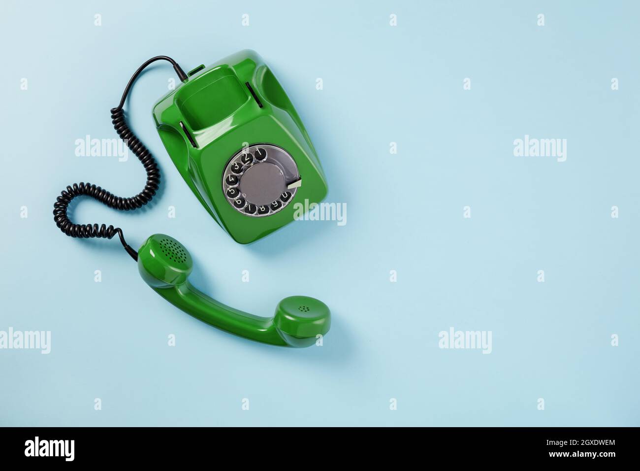 Rotary green phone on blue background Stock Photo - Alamy