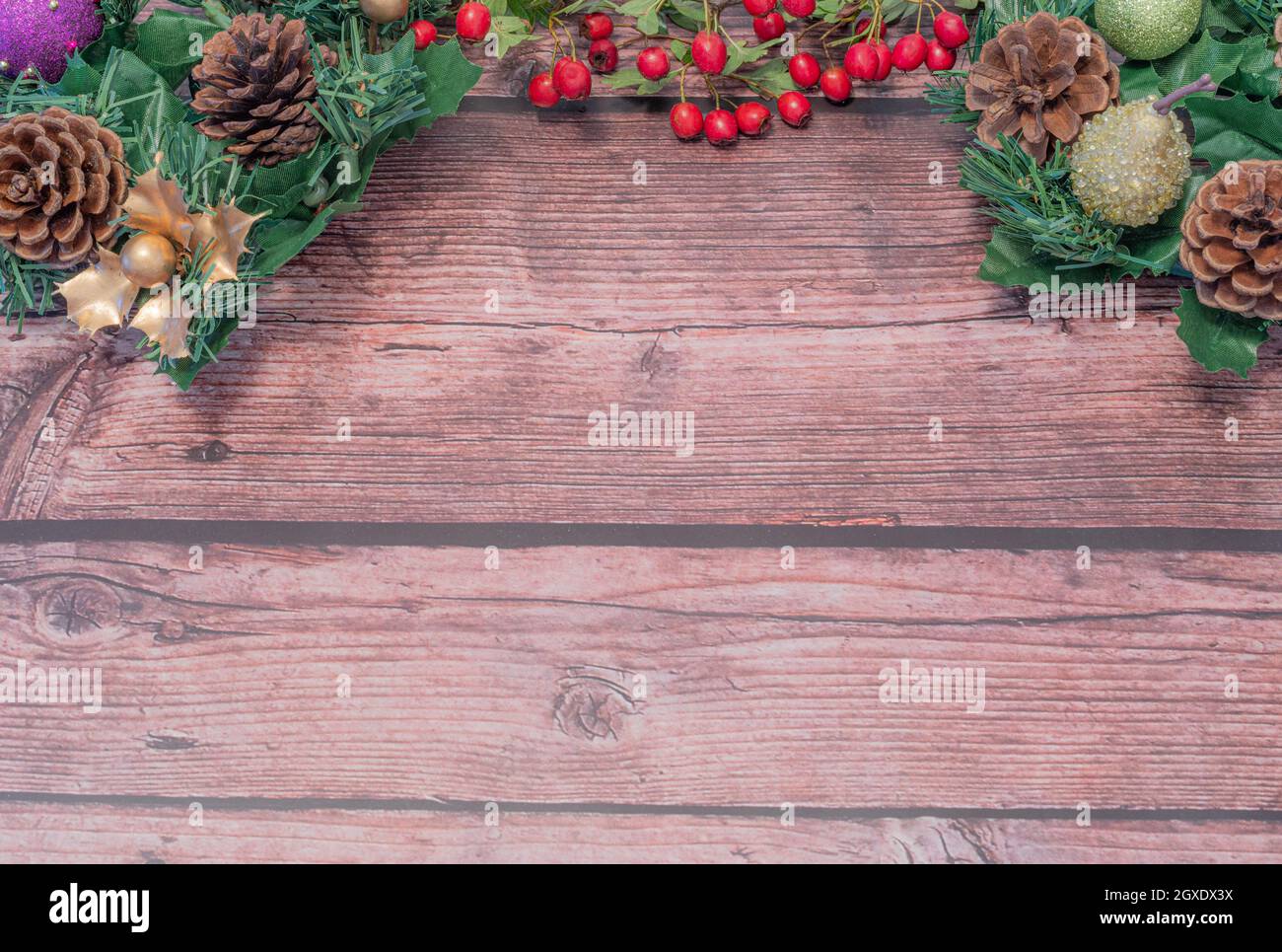 Christmas wreaths and red berries on a wooden table top. copy sace ...