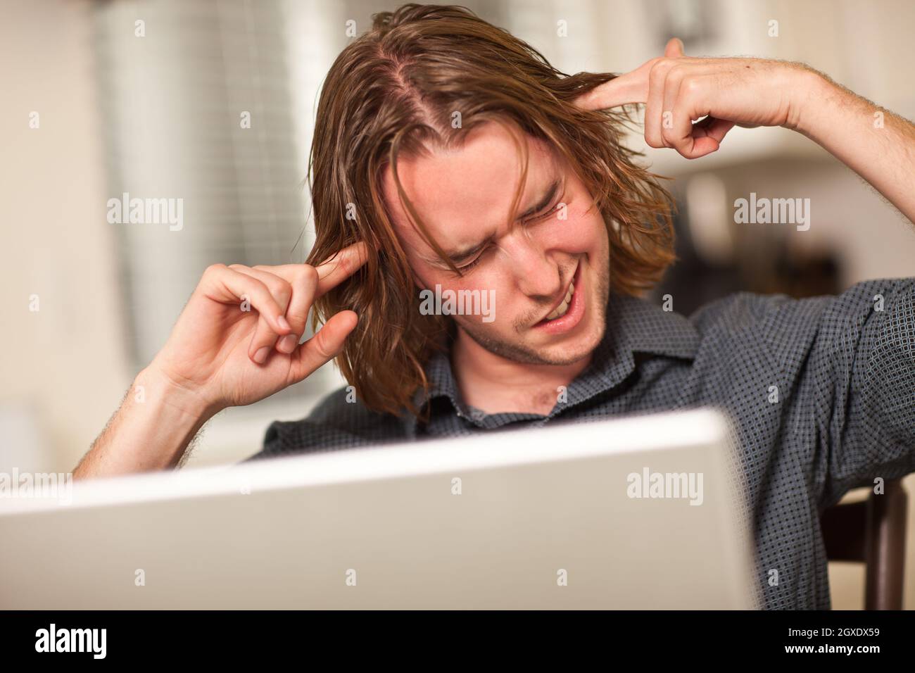 Young Man Getting Loopy While Using His Laptop Computer Stock Photo - Alamy