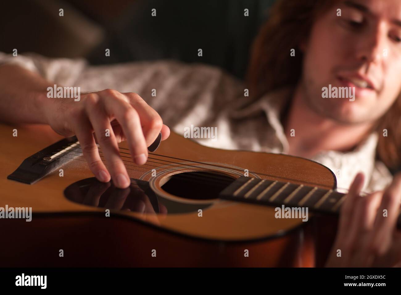 Young Musician Plays His Acoustic Guitar under Dramatic Lighting Stock ...