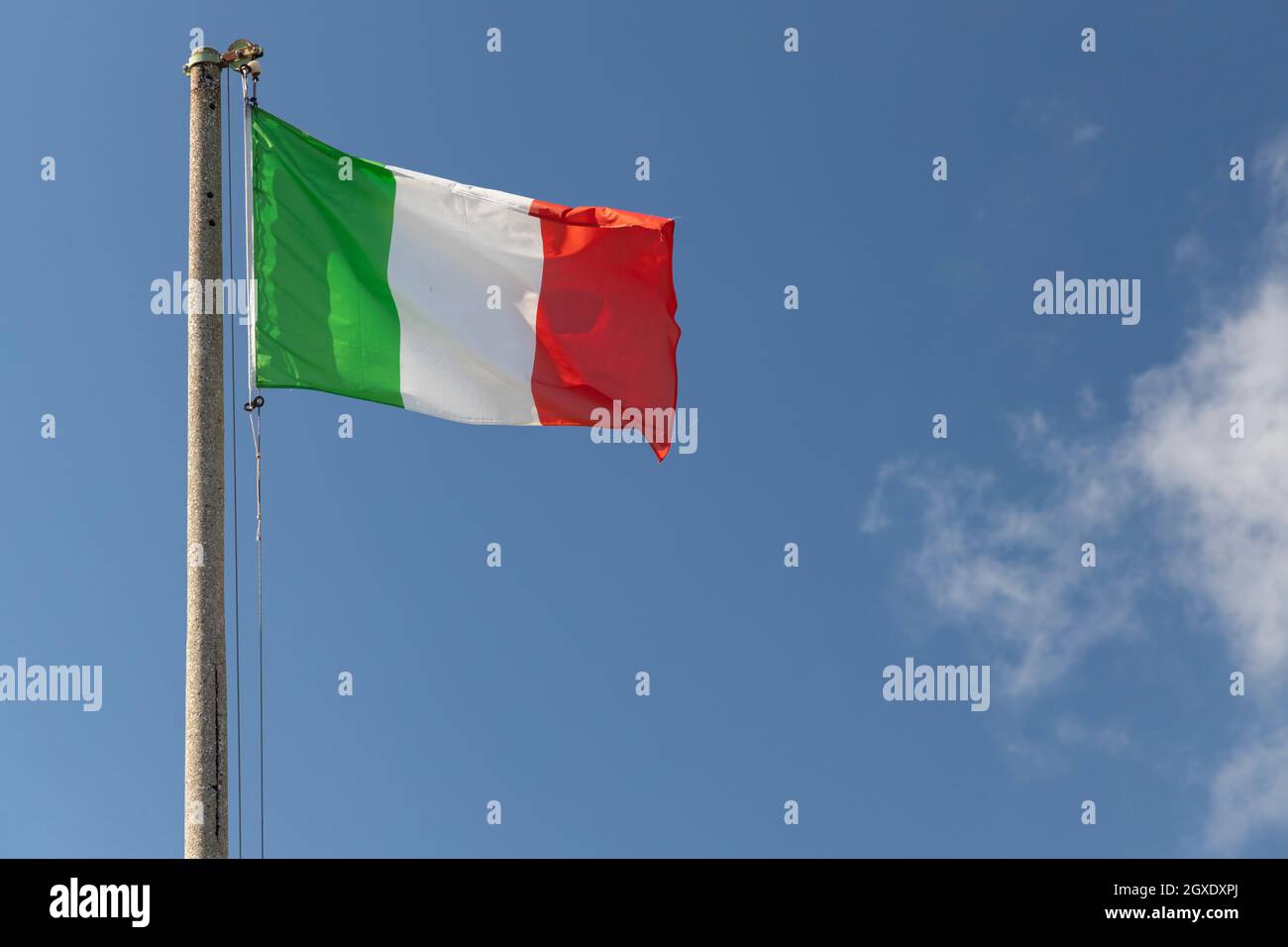 Italian flag blowing in the wind in the blue sky Stock Photo - Alamy