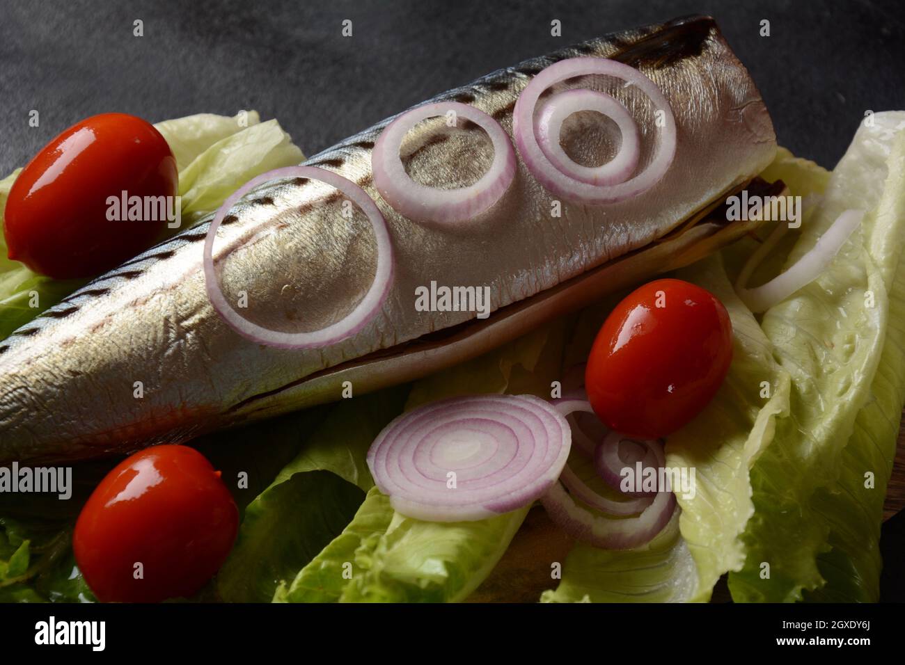 Whole cold-smoked Atlantic mackerel with cherry tomatoes, and red onion ...