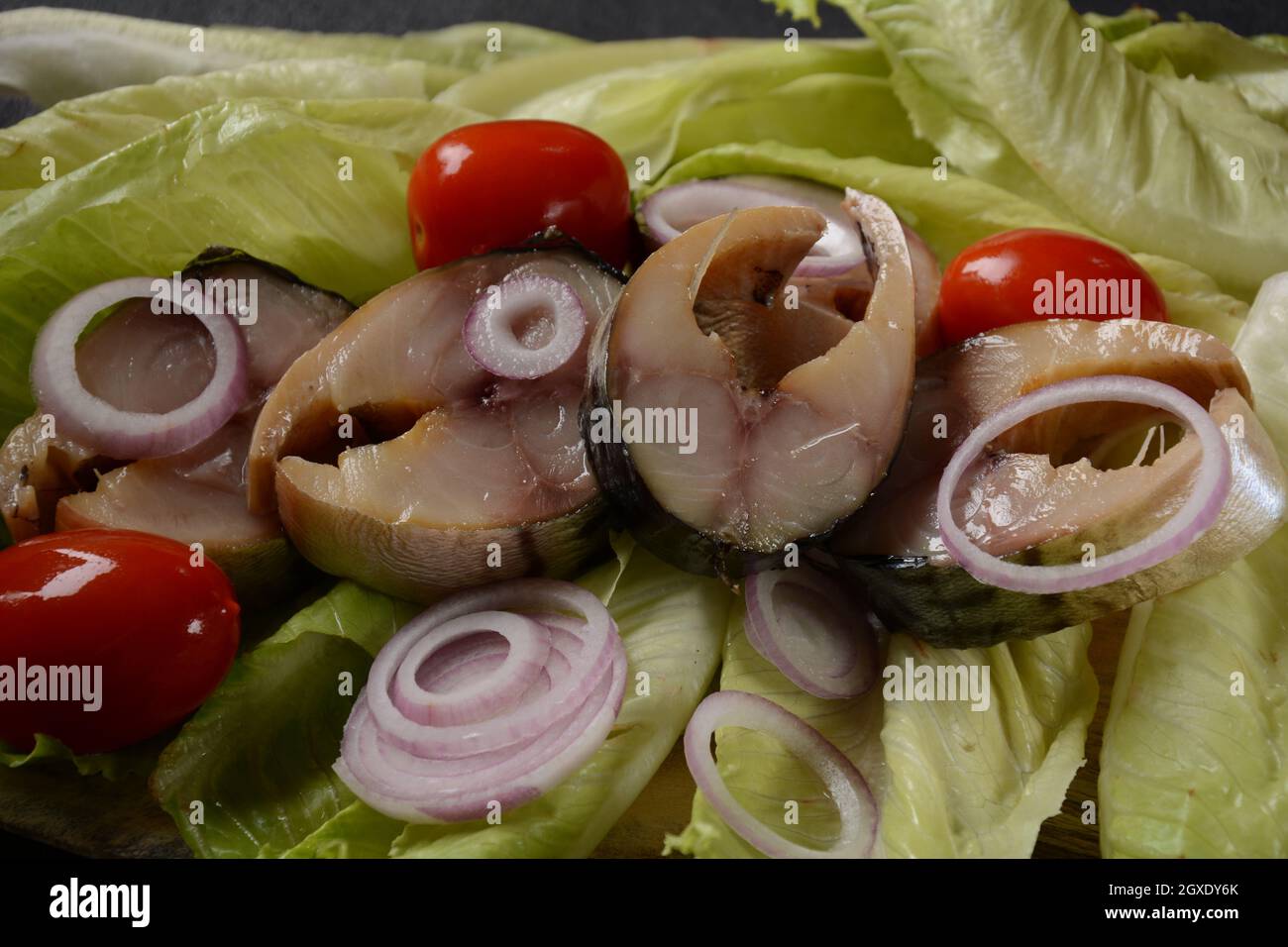Sliced pieces of cold smoked mackerel fish, with cherry tomatoes, and ...