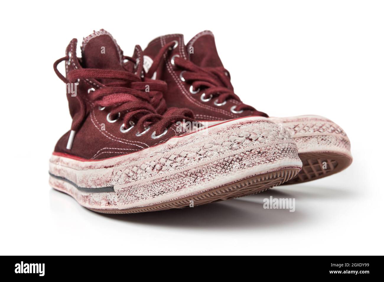 Used canvas shoes on white background Stock Photo - Alamy