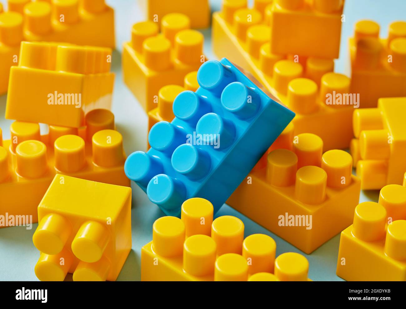 Plastic toy blocks on blue background Stock Photo - Alamy