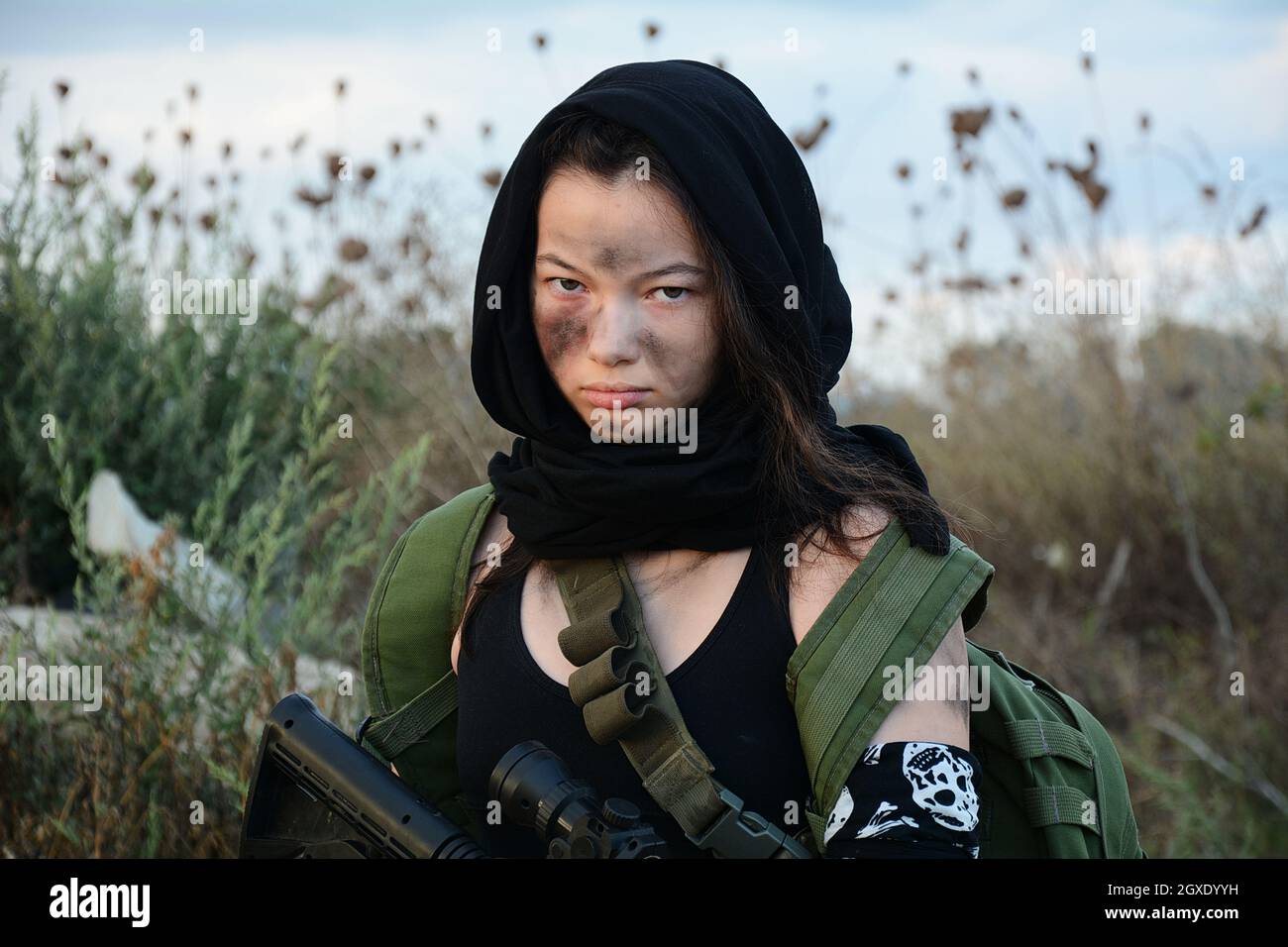 A female militia soldier in a post apocalyptic desert wasteland. Urban ...
