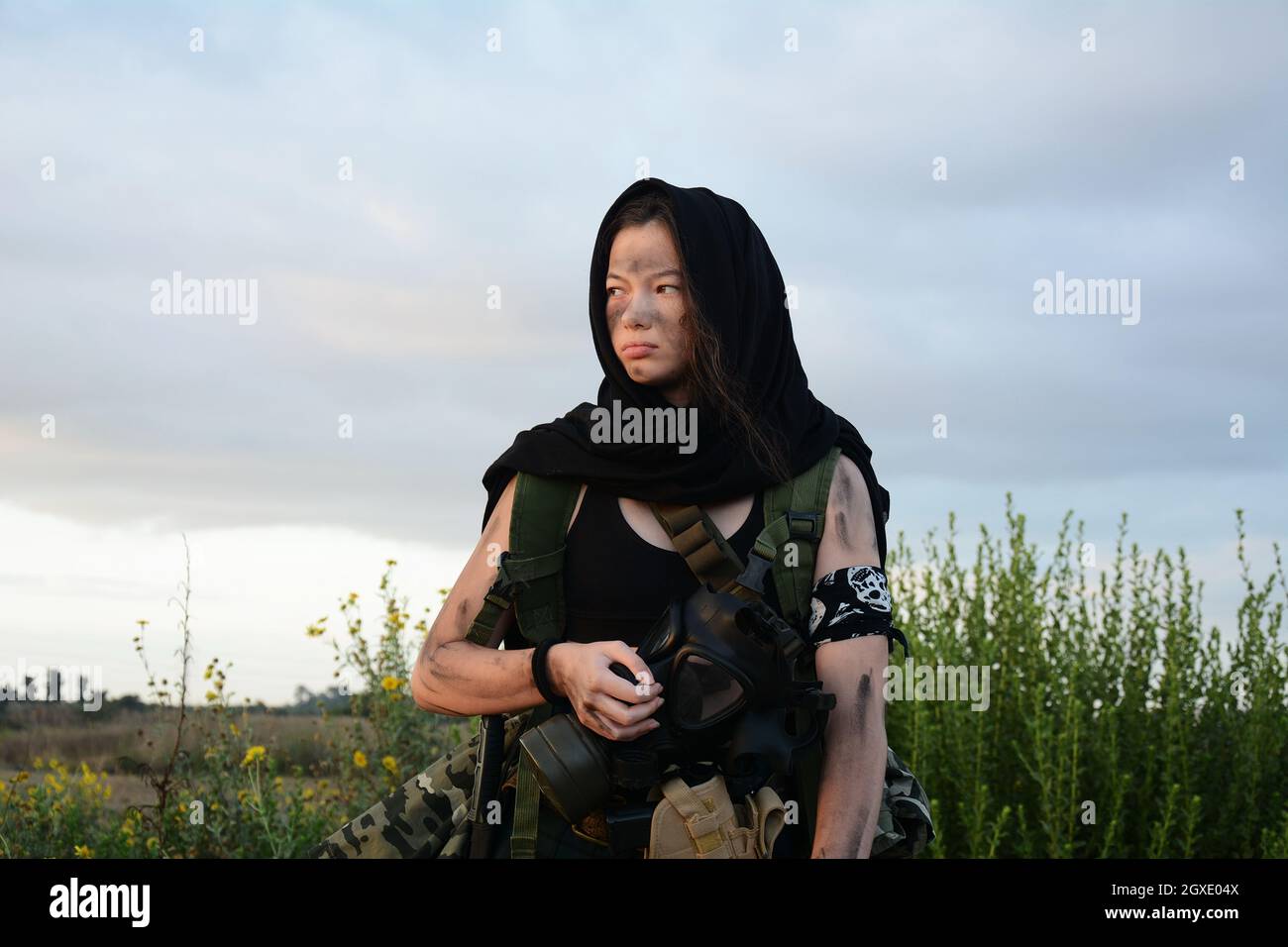 A female militia soldier in a post apocalyptic desert wasteland. Urban ...