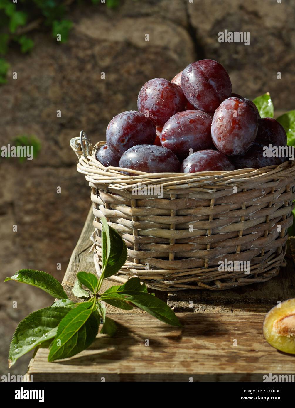 Fresh farm plums with leafs Stock Photo - Alamy
