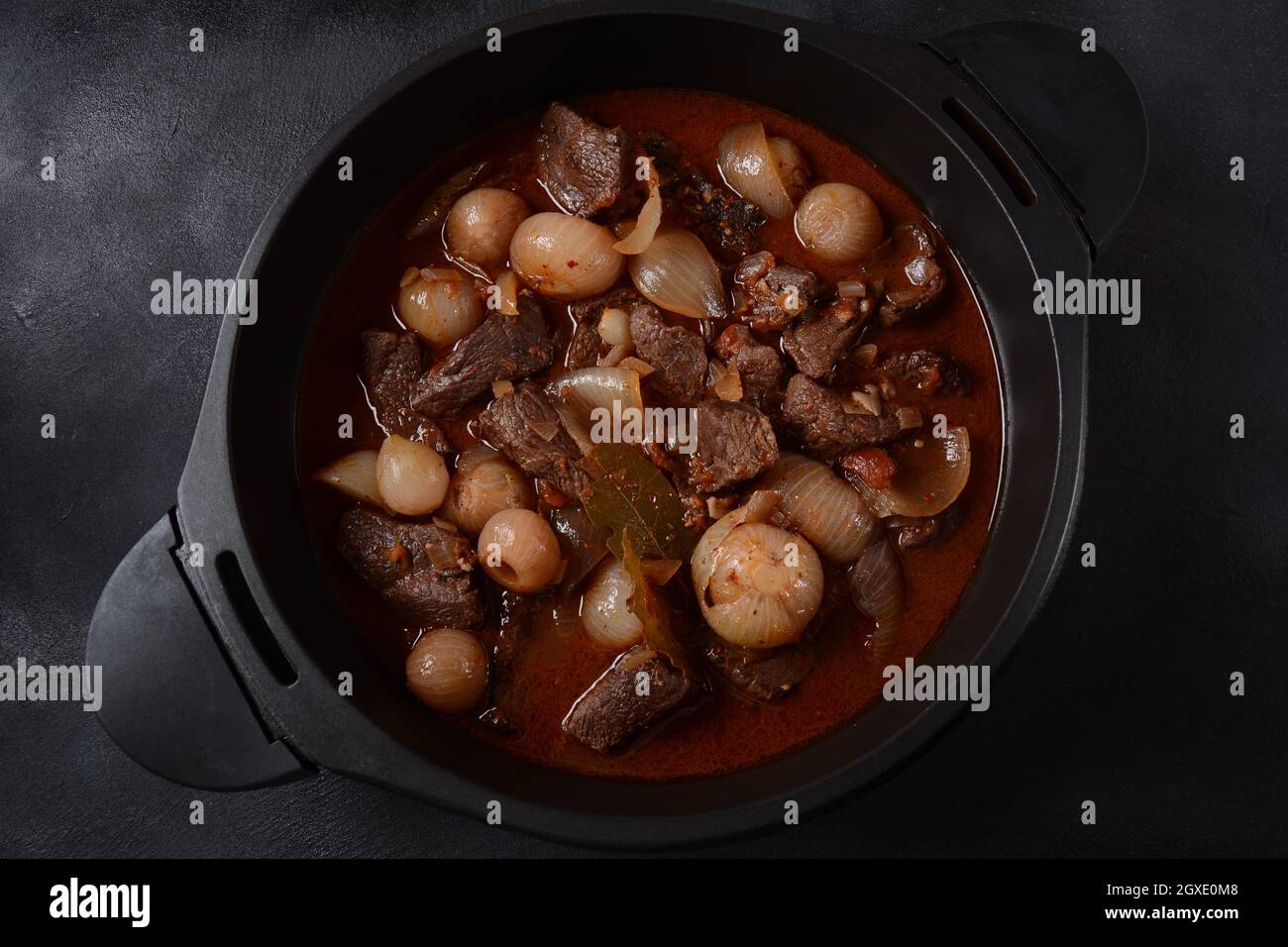 Greek beef stifado. Stew with beef, onion bulbs, cinnamon and spices ...