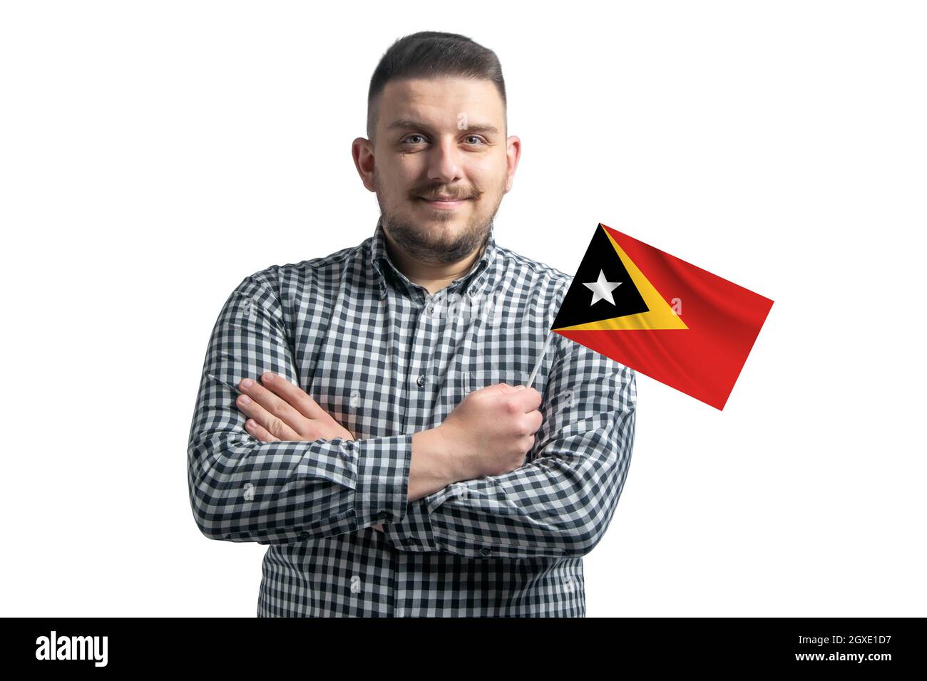 White guy holding a flag of East Timor smiling confident with crossed ...
