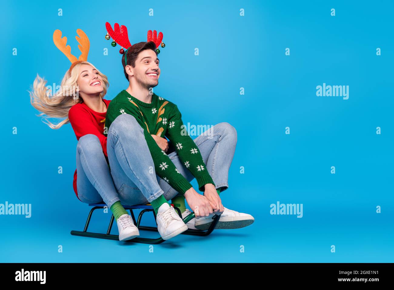 Full length body size photo couple riding sledges together isolated ...