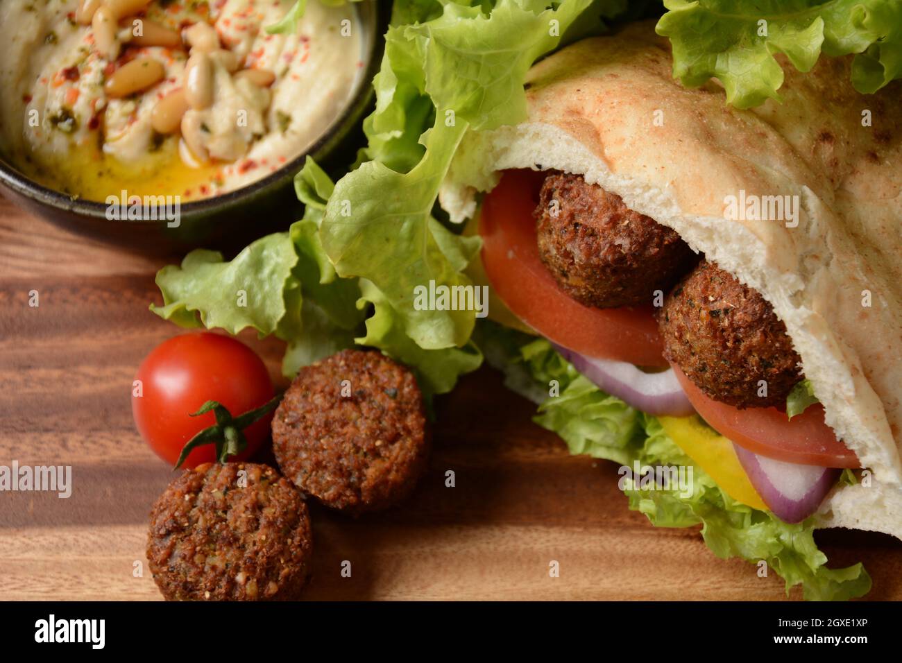 Falafel in pita bread with vegetable salad, harissa sauce, humus ...