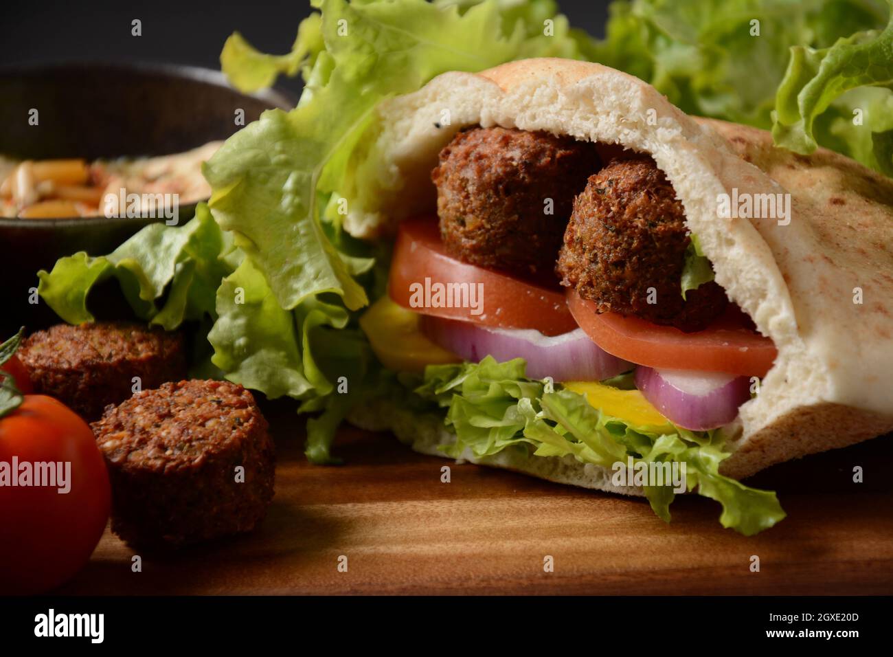 Falafel in pita bread with vegetable salad, harissa sauce, humus ...