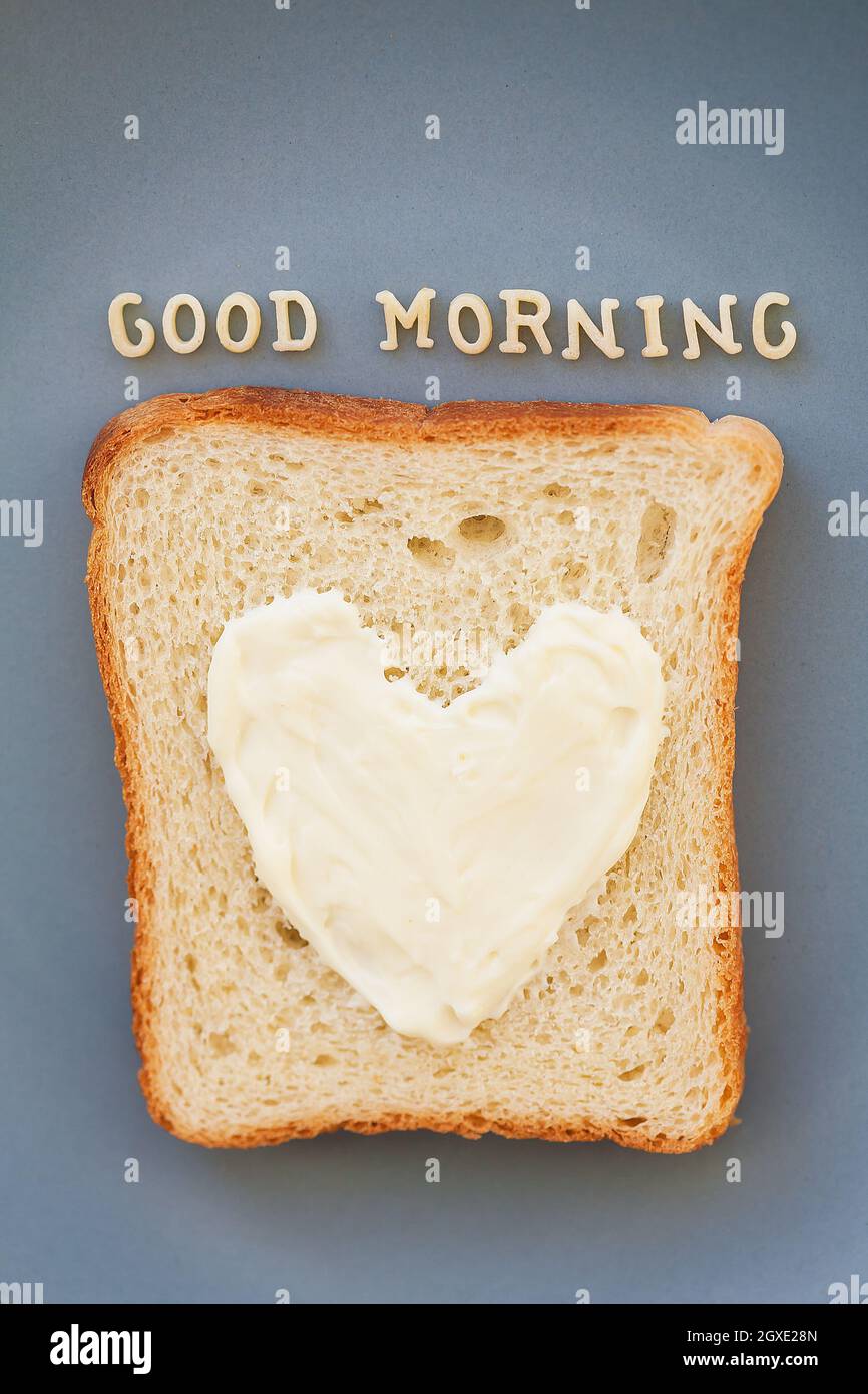 sandwich for breakfast in the form of heart with cheese on a blue plate ...