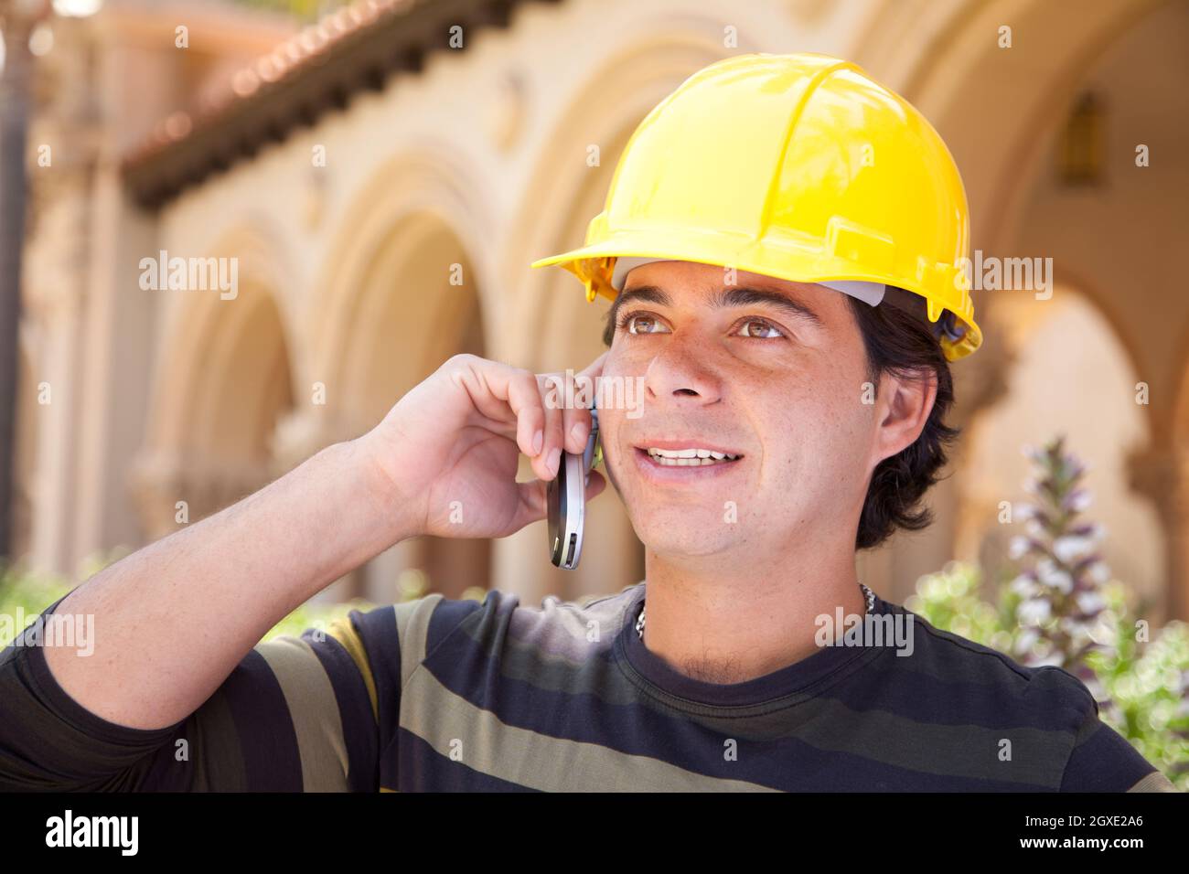 Handsome Hispanic Contractor with Hard Hat Talking on His Cell Phone ...