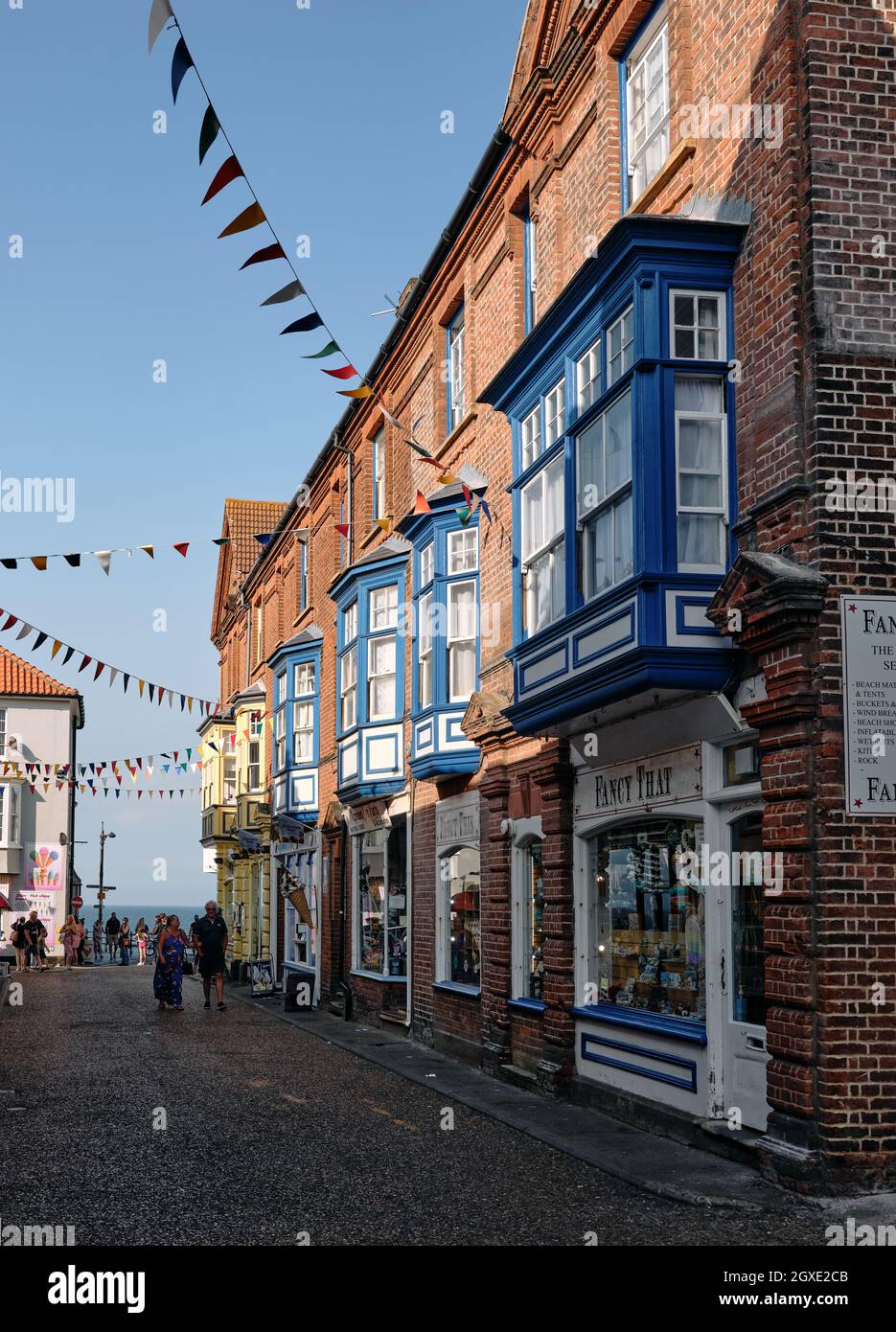 The narrow streets and shops in the traditional seaside resort town of ...