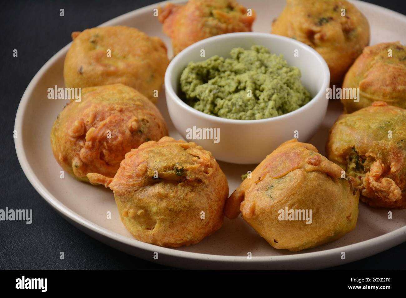 Batata vada popular street food of India, Served with green chutney ...