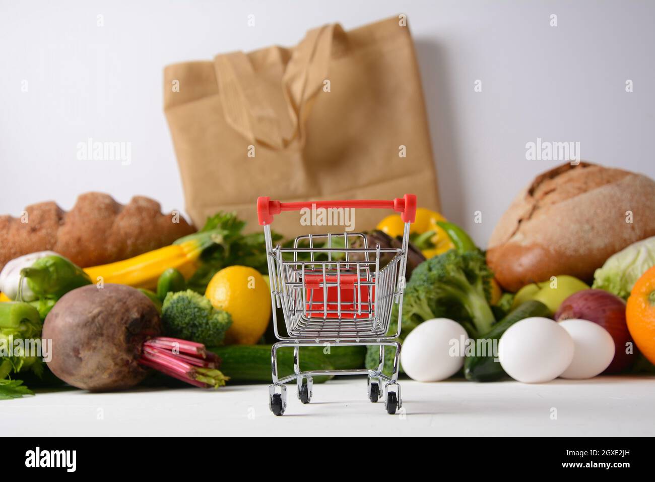 Shopping trolley cart and different groceries .Healthy food background ...