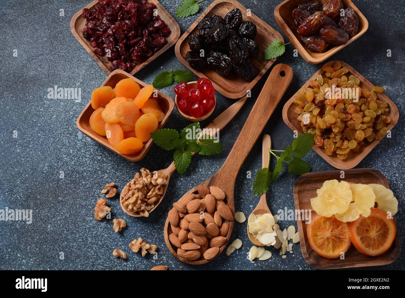 Mix of dried and sun-dried fruits, in a wooden trays . View from above ...