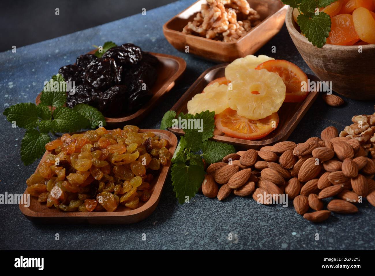 Mix of dried and sun-dried fruits, in a wooden trays . View from above ...