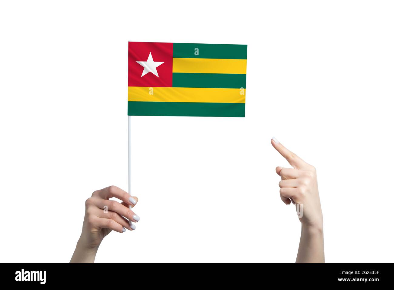 A beautiful female hand holds a Togo flag to which she shows the finger ...