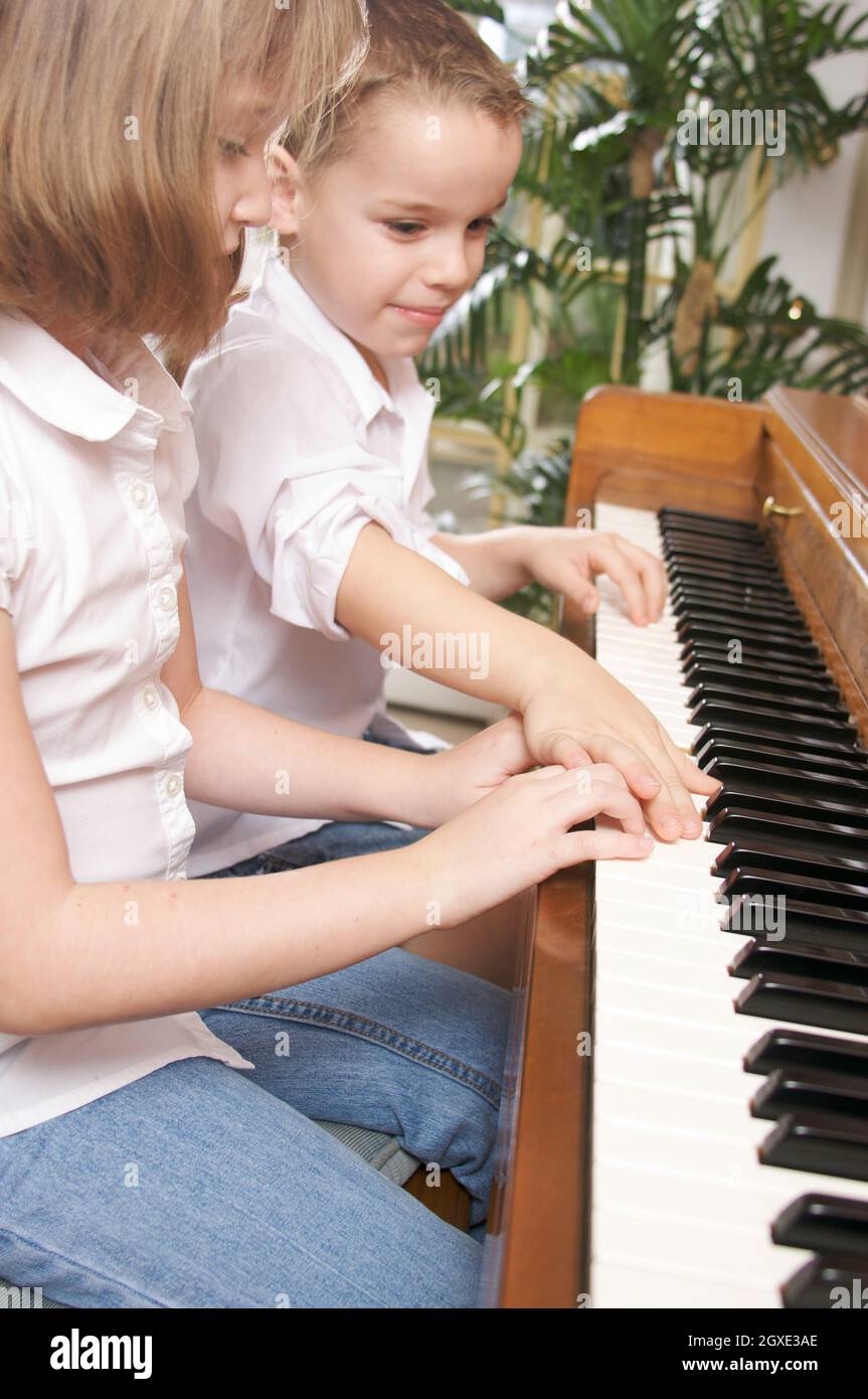 Brother and Sister Playing the Piano Together Stock Photo - Alamy