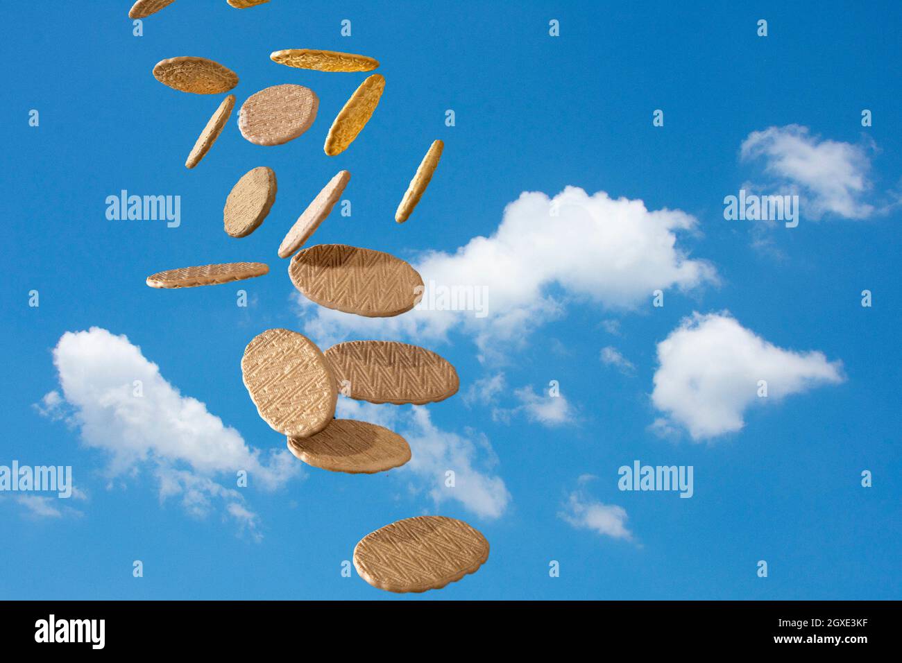 Fragrant, delicious biscuits fly against a blue sky with white clouds ...