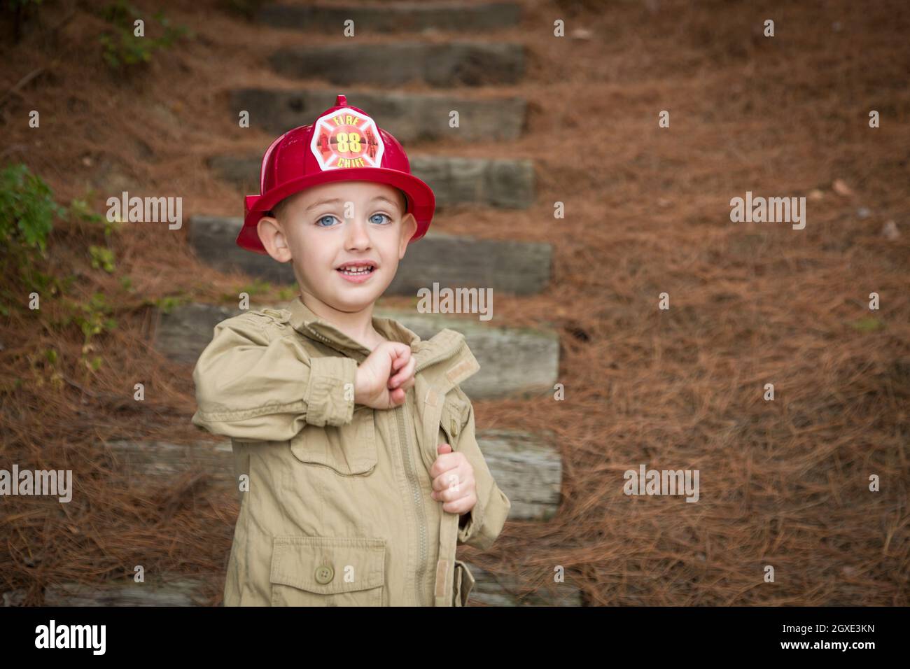 Happy Adorable Child Boy with Fireman Hat Playing Outside Stock Photo ...