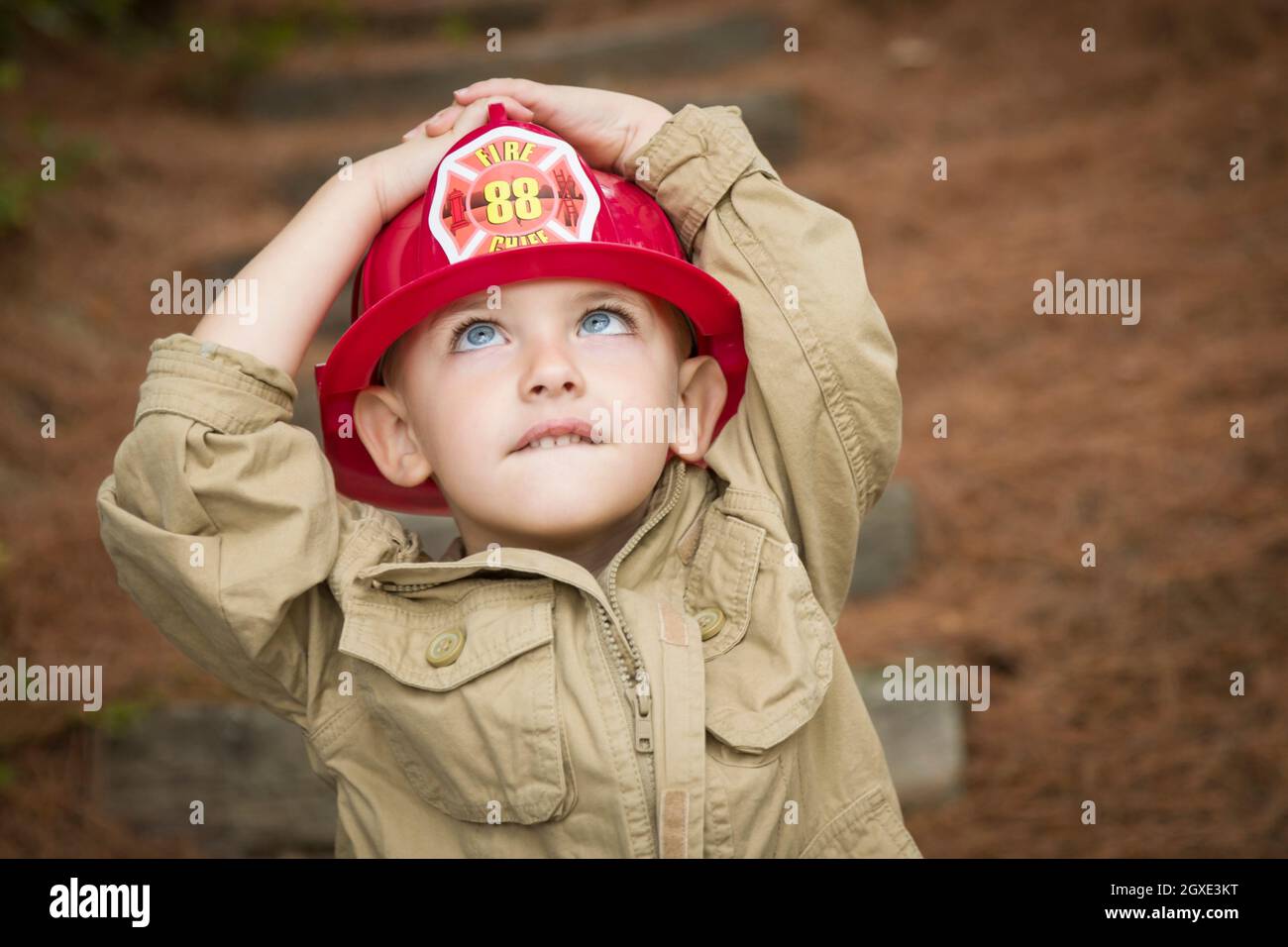 Happy Adorable Child Boy with Fireman Hat Playing Outside Stock Photo ...