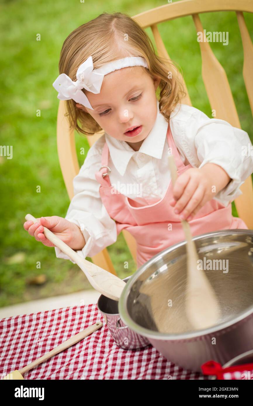 Happy Adorable Little Girl Playing Chef Cooking in Her Pink Outfit ...