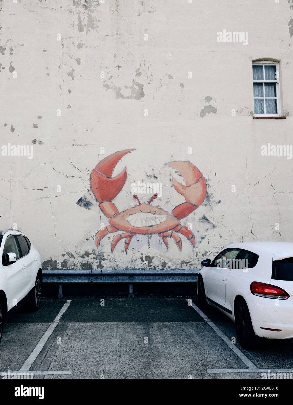 A smiling crab mural artwork street art in a car park in the ...