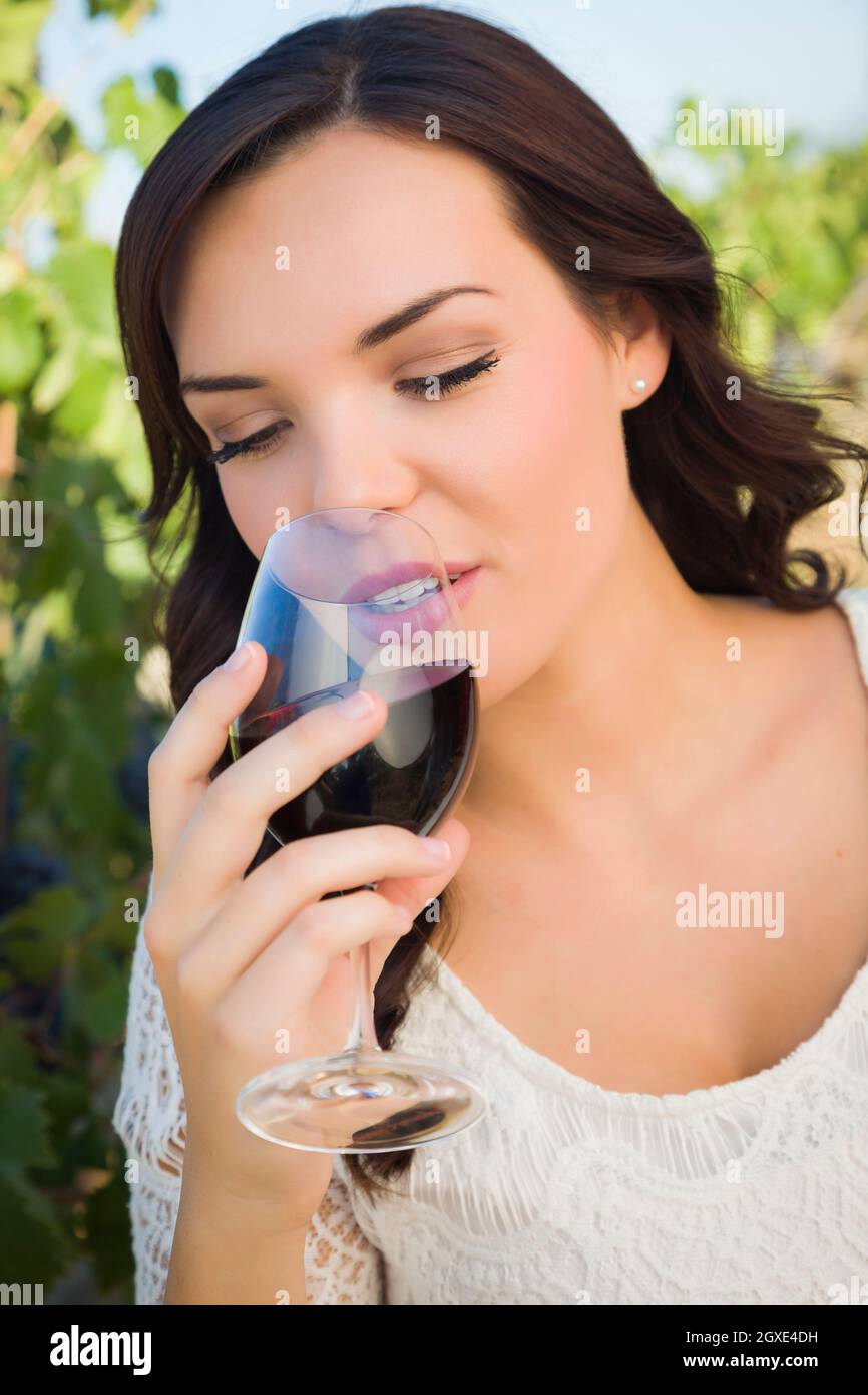 Pretty Mixed Race Young Adult Woman Enjoying A Glass of Wine in the ...