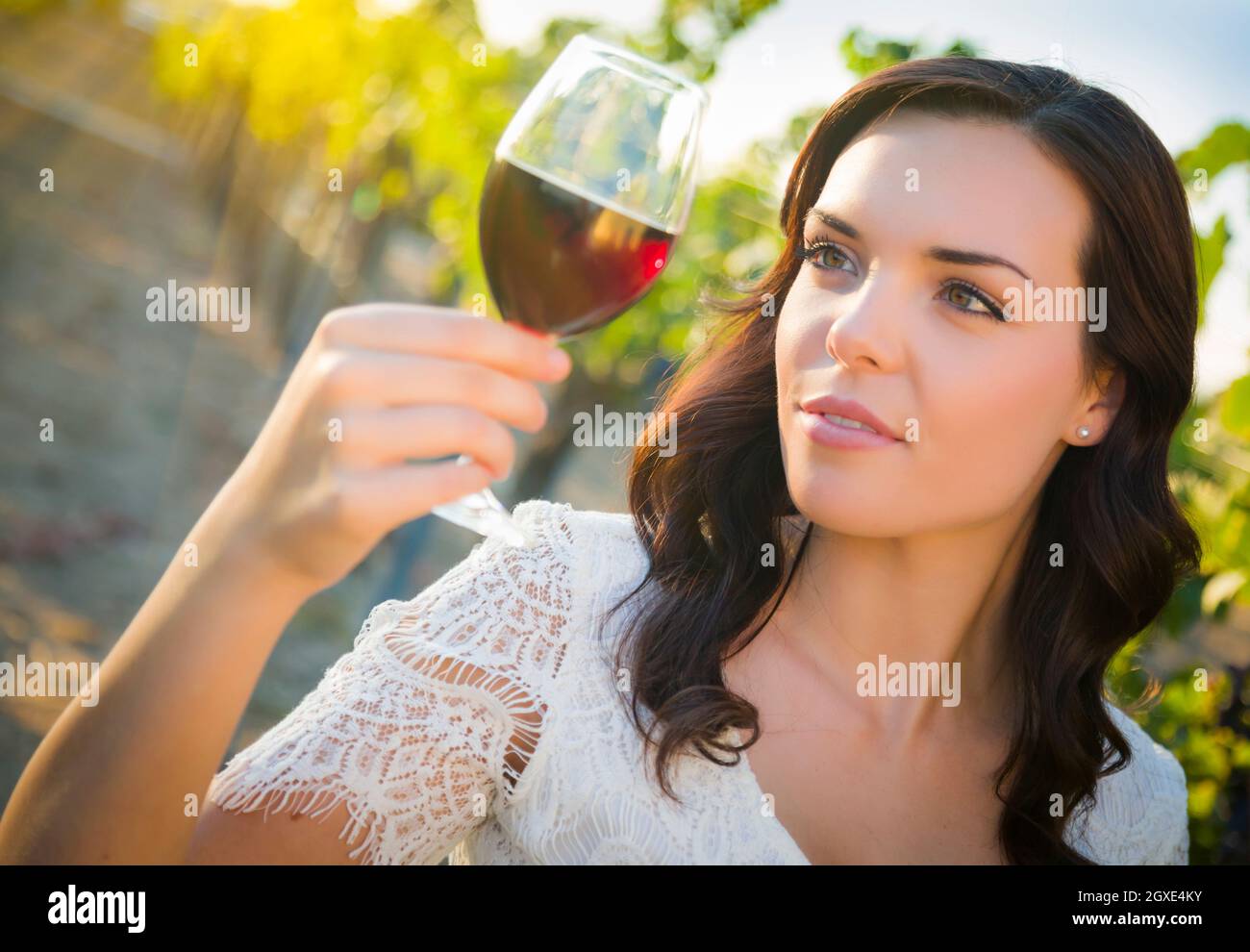 Pretty Mixed Race Young Adult Woman Enjoying A Glass of Wine in the ...