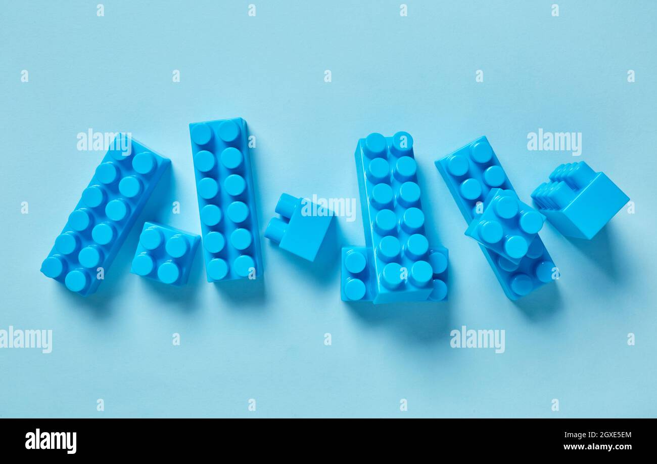 Blue toy bricks on blue background Stock Photo - Alamy