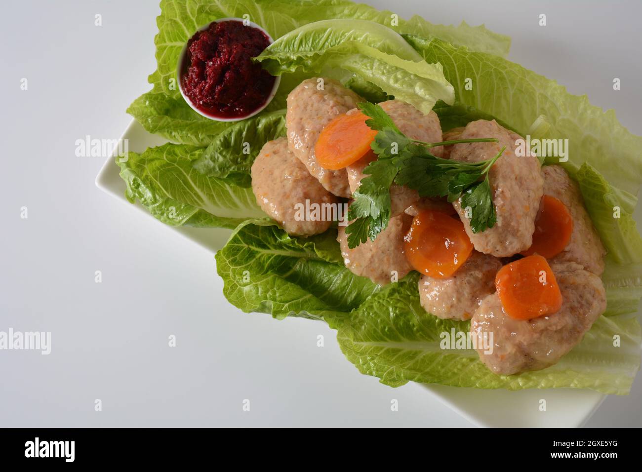 Gefilte fish with carrots, lettuce, horse radish . Passover traditional ...