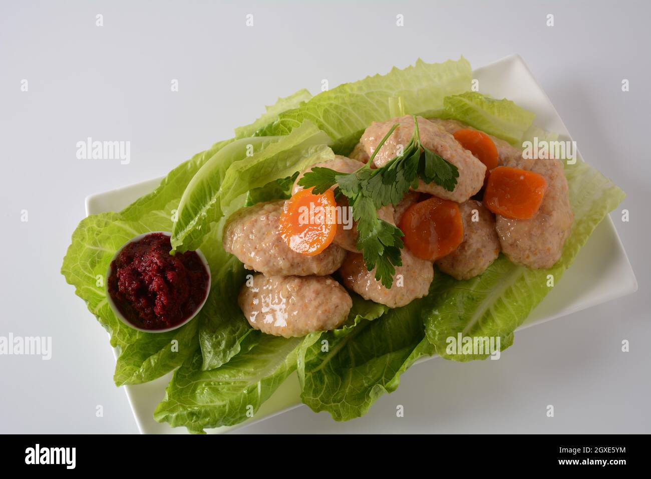 Gefilte fish with carrots, lettuce, horse radish . Passover traditional ...