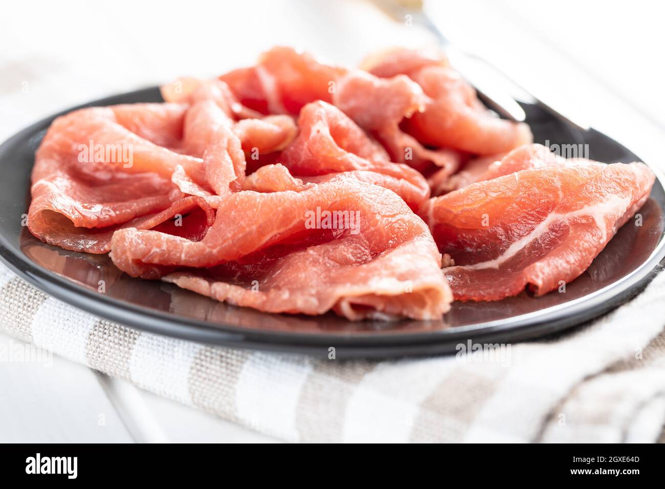 Sliced carpaccio. Raw beef meat on plate Stock Photo - Alamy